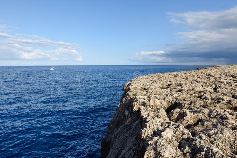 View Over the Ocean from a Cliff As a Boat Sails in the Distance Stock ...