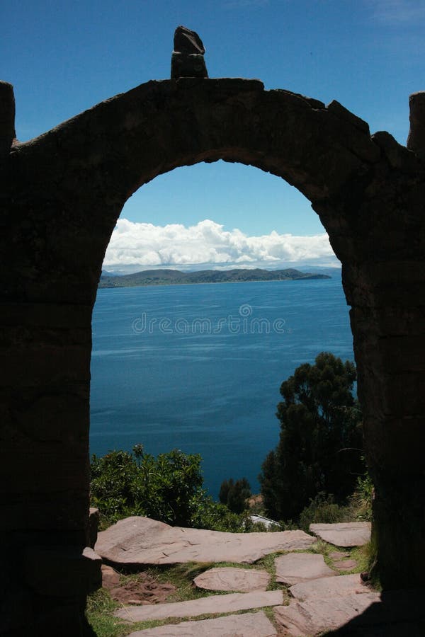 View Over the Ocean through a Stone Gate Covered in Shadows Stock Photo ...