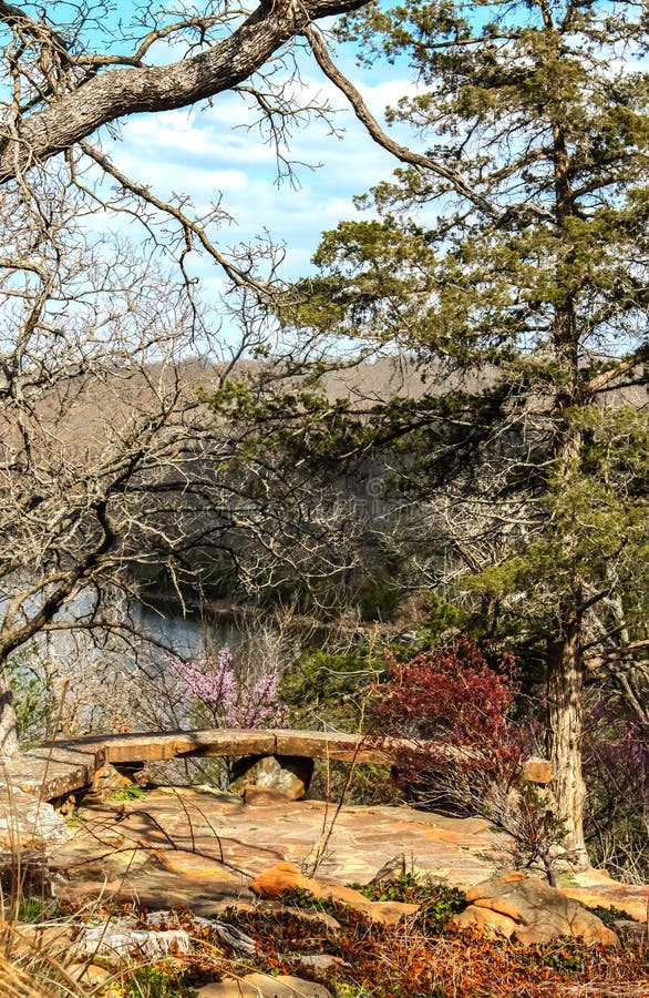 View Over River and Bluffs in Early Springtime with Circular Rock Bench ...