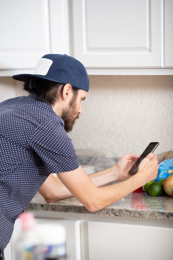 Man leans kitchen - OTS stock image. Image of hold, media - 178007989