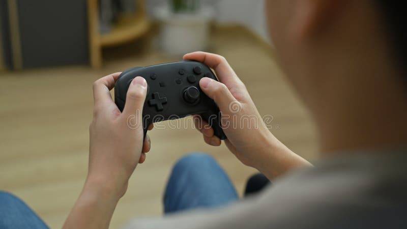 View Over Shoulder of Young Man Holding Wireless Controller Playing ...