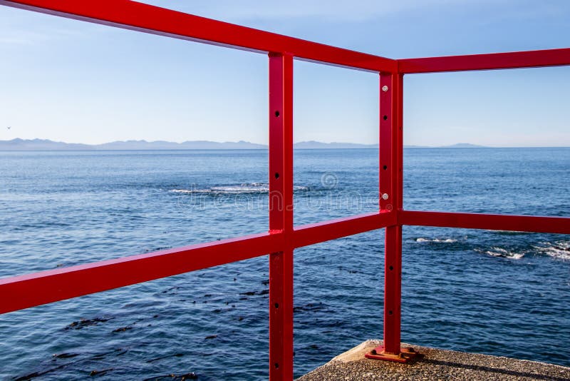 View of Pacific Ocean from Behind a Red Metal Railing Stock Photo ...
