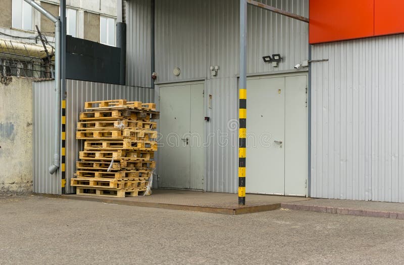 View on Pallets, Used Containers, Boxes in Front of the Door of the ...