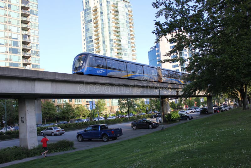 View of a Park by the Sky Train Under the Blue Sky in Downtown ...