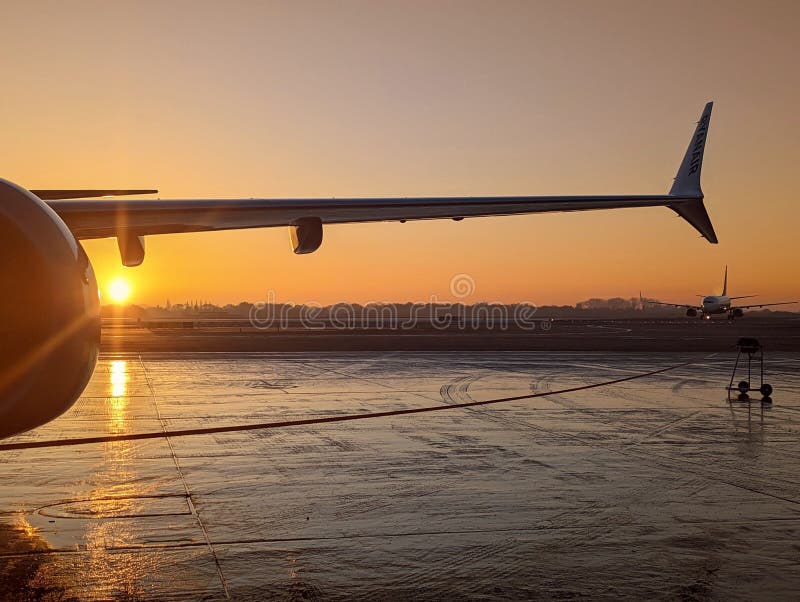 View of the Parked Airplane Wing on a Sunset Stock Photo - Image of ...