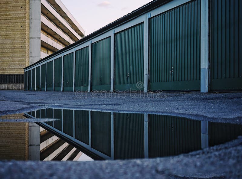 View of Parking Garage Next To Puddle Stock Photo - Image of garage ...