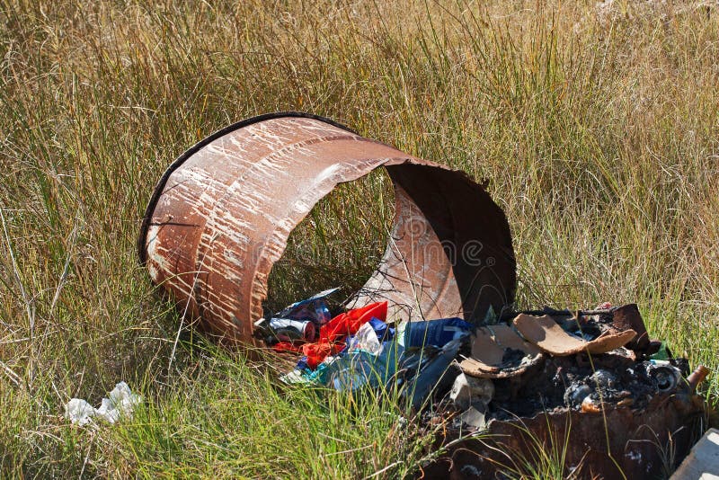 VIEW of PART of a FALLEN OVER REFUSE BIN EXPOSING RUBBLE and TRASH ...