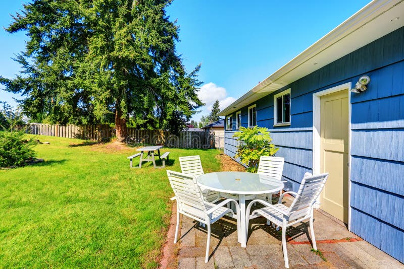 View of Patio Table Set in the Blue House Back Yard. Stock Image ...