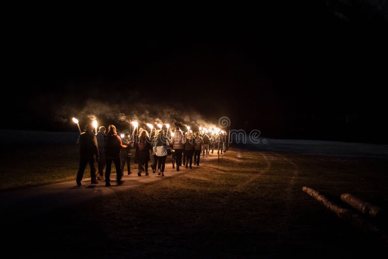 View of People Walking with Torches in a Dark Street during the Night ...