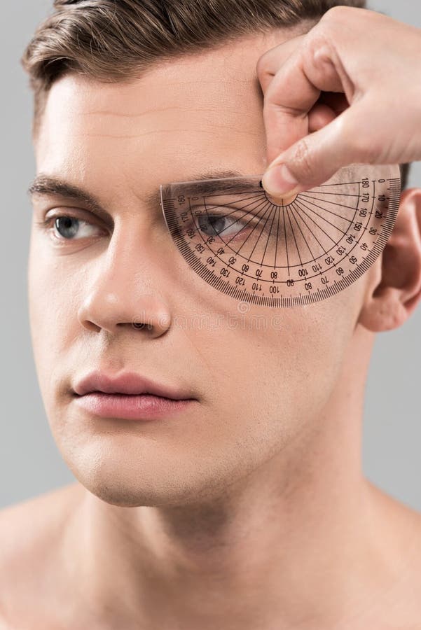 View of Plastic Surgeon Measuring Face with Protractor Isolated on Grey ...