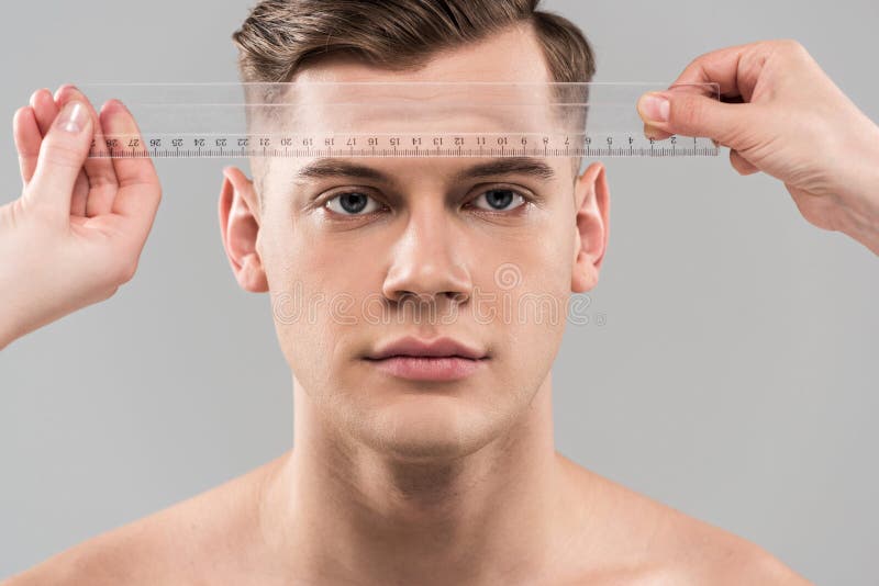 View of Plastic Surgeons Measuring Face with Ruler Isolated on Grey ...