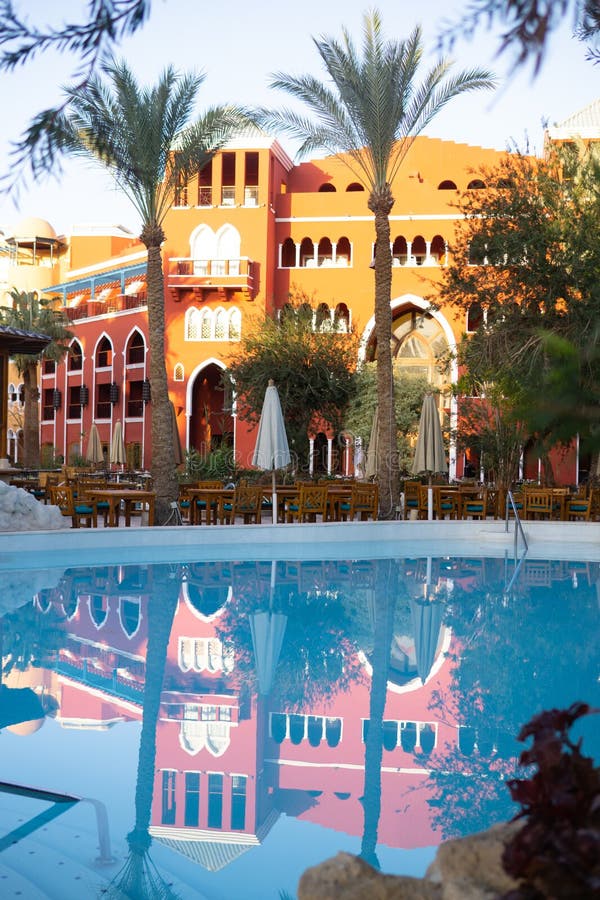 View of the Pool, Palm Trees and the Reflection of the Sun on the ...