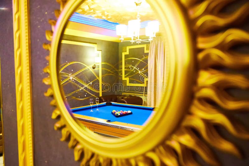 A View of a Pool Table Reflected in a Round, Ornate Mirror Stock Image ...