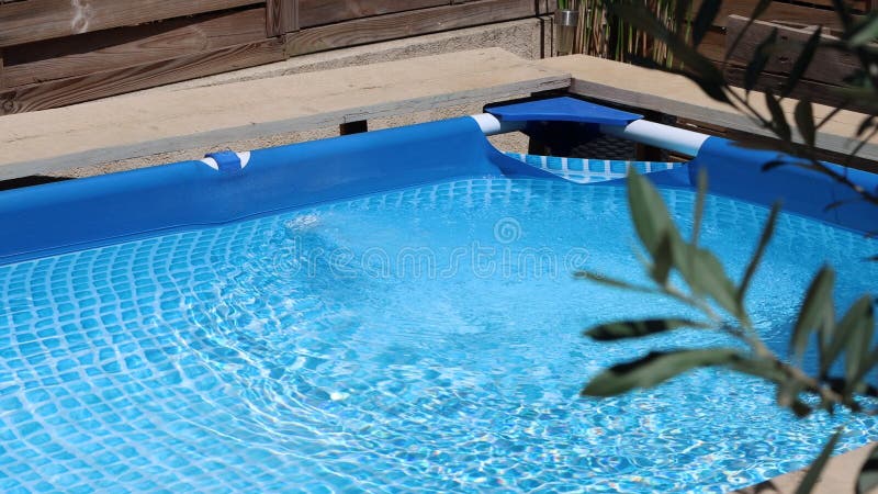 View of a Pool with the Water Filtering Pump Working on a Sunny and ...