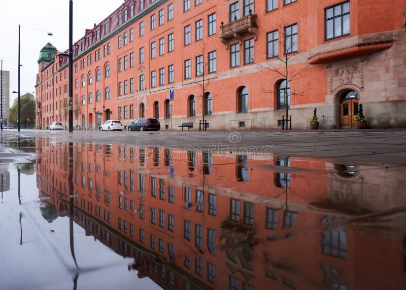 View of Puddle on Street Next To Building in City Stock Photo - Image ...