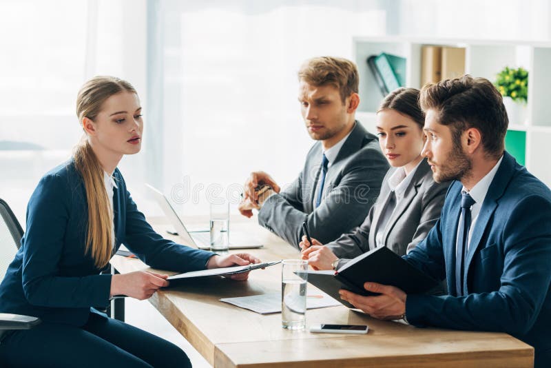 View of Recruiters Looking at Employee with Clipboard during Job ...
