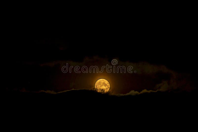 Red Moon Half Hidden by Thick and Compact Clouds at Night Stock Photo ...