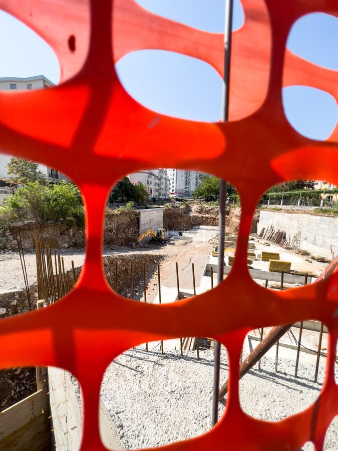 View through the Red Plastic Signal Mesh To the Construction Site Stock ...