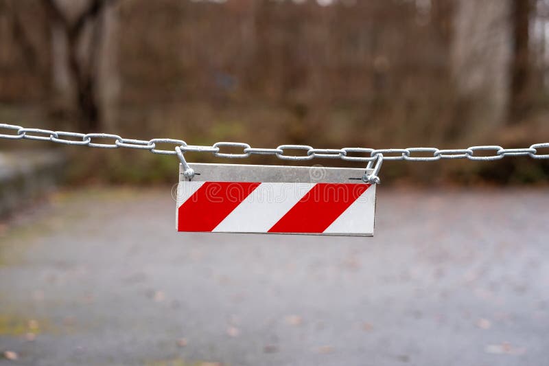 View of a Red and White Diagonal Striped Sign Hanging on a Chain Stock ...