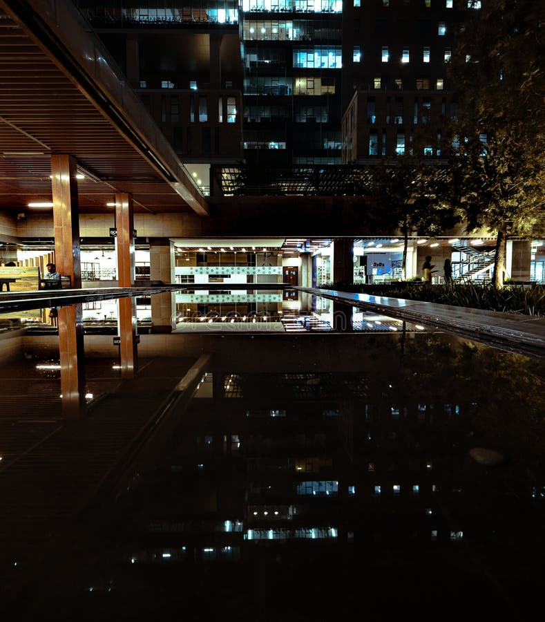 View of a Residential Building with Lights at Night and the Reflection ...