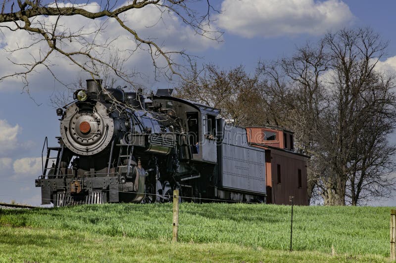 View of a Restored Steam Passenger Train Traveling Thru Open Fields and ...