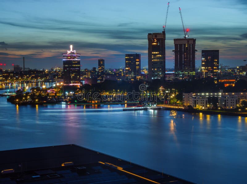 View of a River with Adam Tower and Modern Buildings in the Background ...