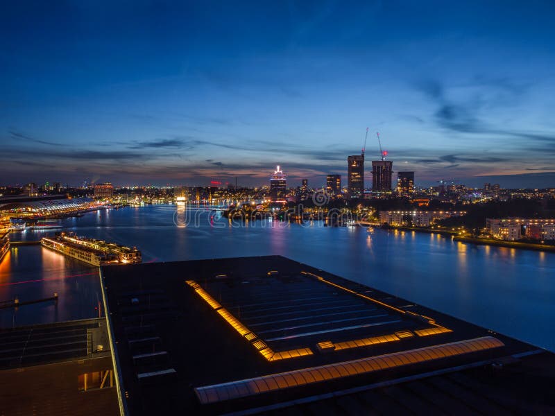 View of a River with Adam Tower and Modern Buildings in the Background ...
