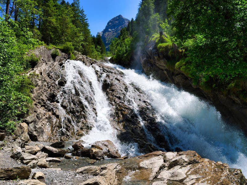 View of a River Falling Down a Rocky Slope in the Forest Under the Blue ...