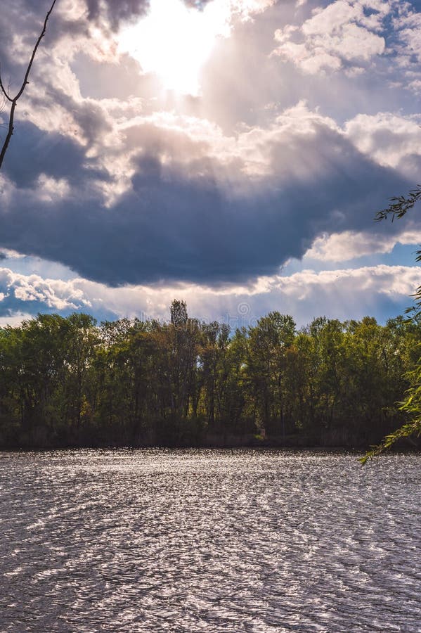 View of the River, Trees and Sky.Sun Glare on the Water.Cloudy Sky Over ...