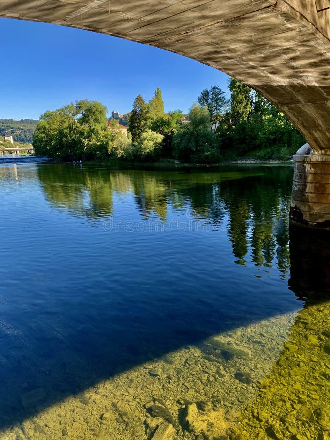 View of the River from Under the Bridge Stock Photo - Image of trees ...