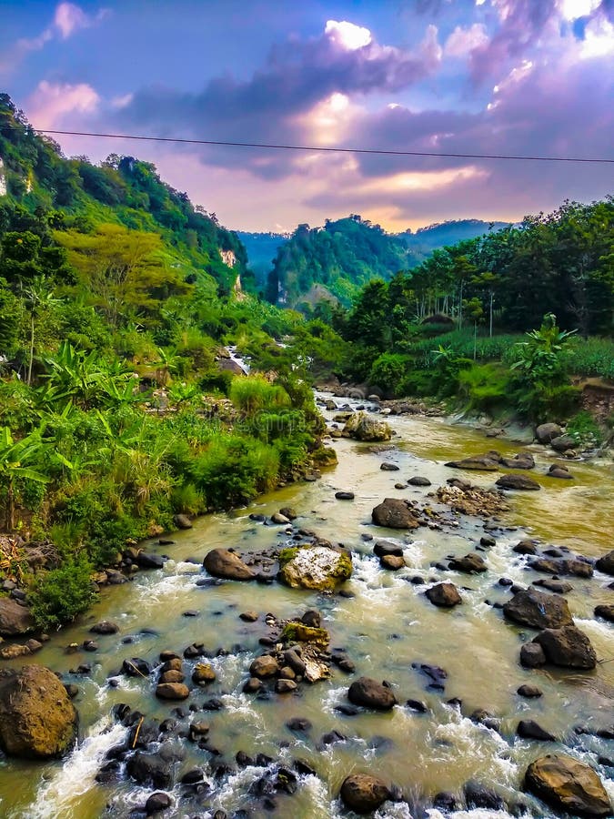 The View on the River Which is Full of Rocks in it with the Cloudy Sky in the Afternoon Stock ...
