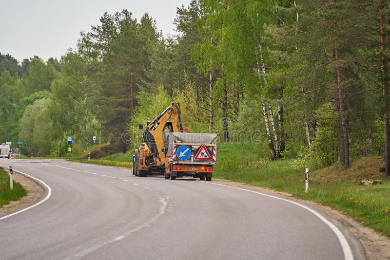 View of Road Repair Vehicles with Warning Signs on the Road Editorial ...
