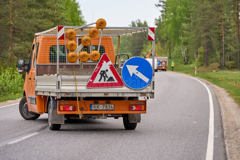 View of Road Repair Vehicles with Warning Signs on the Road Editorial ...