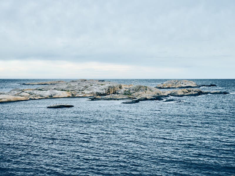 View of Rock Formations in the Middle of the Blue Ocean, on a Cloudy ...
