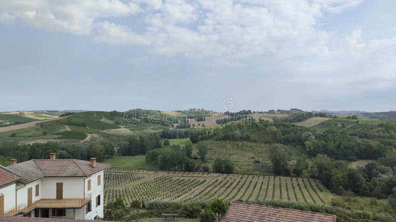 View of Rolling Hills with Trees, Buildings, and Sky. Serene Landscape ...