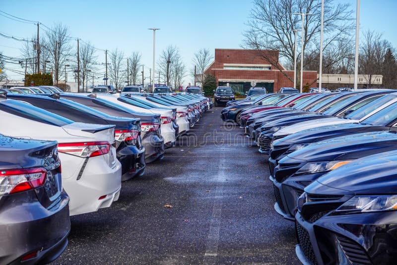 View of Rows of Various Colored New Cars in a Parking Lot with a Access ...