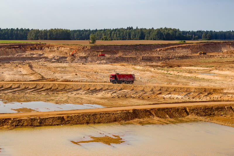View of a Sand Pit and a Moving Red Dump Truck in the Distance Stock ...