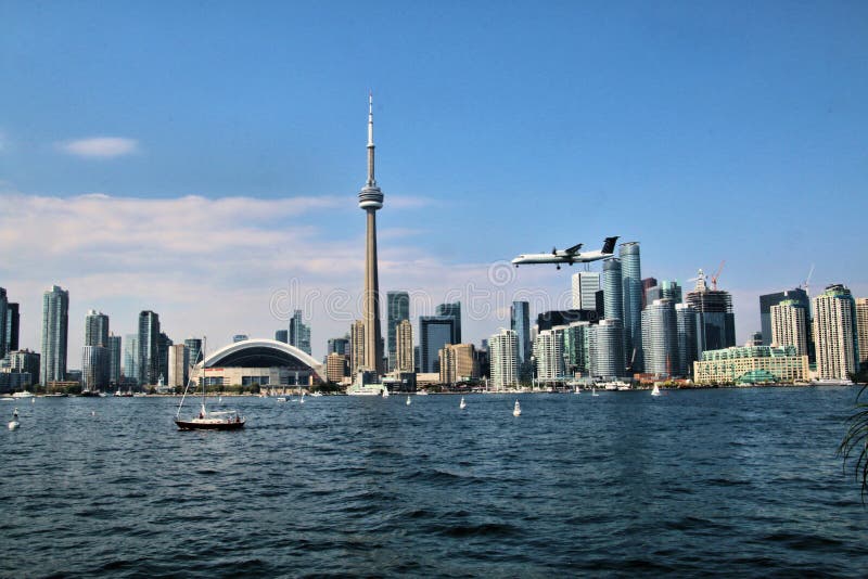 A View of the Sea Front at Toronto with a Plane Flying in Stock Image ...