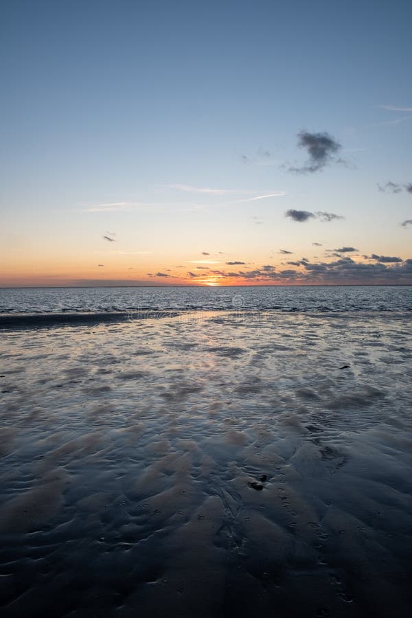 View of the Setting Sun Shining on the Sea and Reflected on the Beach ...