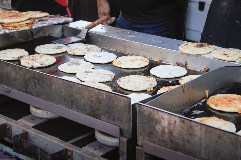 Pupusas on the griddle stock image. Image of setting - 254816319