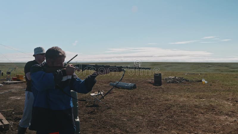 Back View of Unrecognizable Shooter Shooting into Target. Gun ...