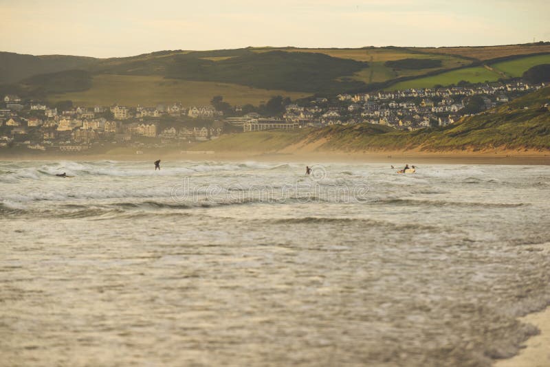 View from the Shore at the Beach with People Surfing Ocean Waves in the ...