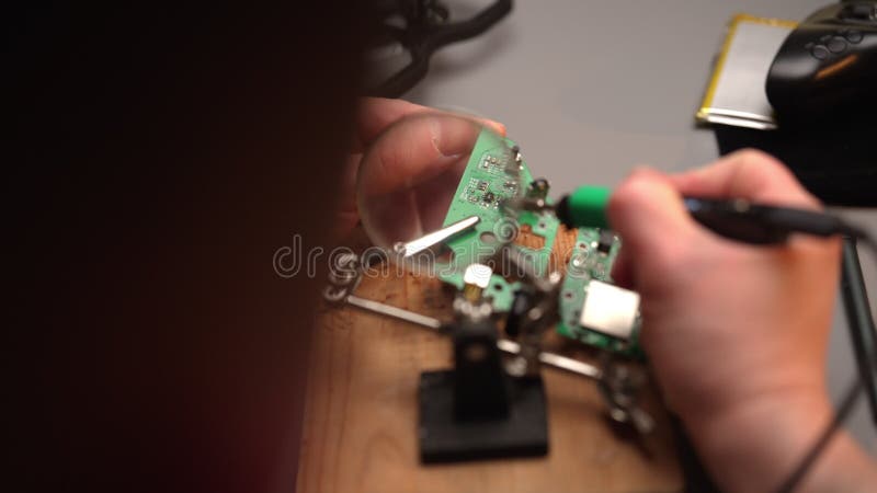 View from Shoulder of Electronic Technician Using Soldering Iron To ...