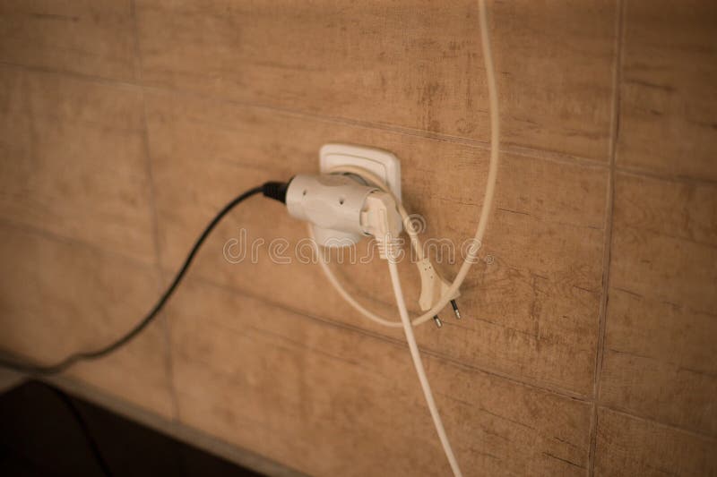 Electrical Outlet with Multiple Cables Connected in Kitchen Background ...