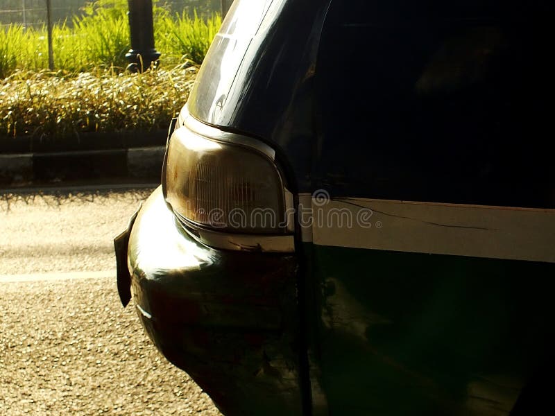 View from Side of a Car with a Green Stripe and White on the Side Stock ...