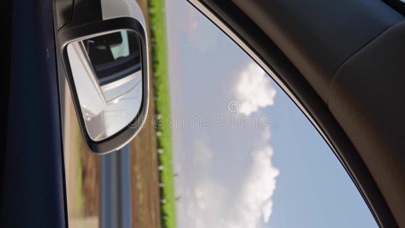 View from Side Mirror the Inside of a Driving Car Along Highway in a ...