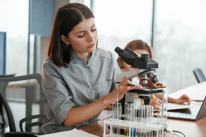 View from the Side. Two Female Doctors are Working Indoors Together ...