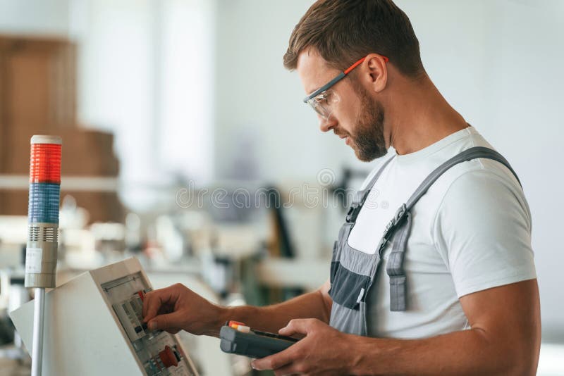 View from the Side, Using Machine. Handsome Man is Working at the ...