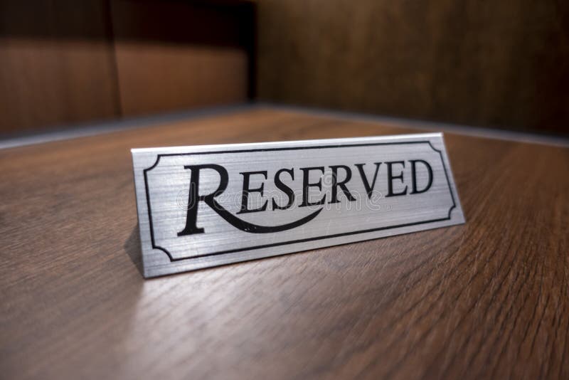 View of a Silver Metal Reserved Placard on a Rich, Wooden Table Stock ...