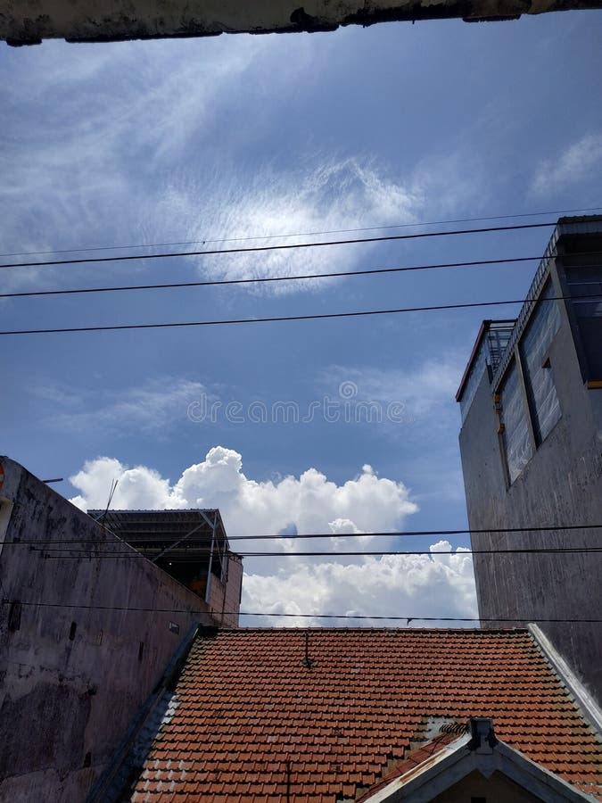 View of the Sky and Power Lines Above the Rooftops Stock Image - Image ...